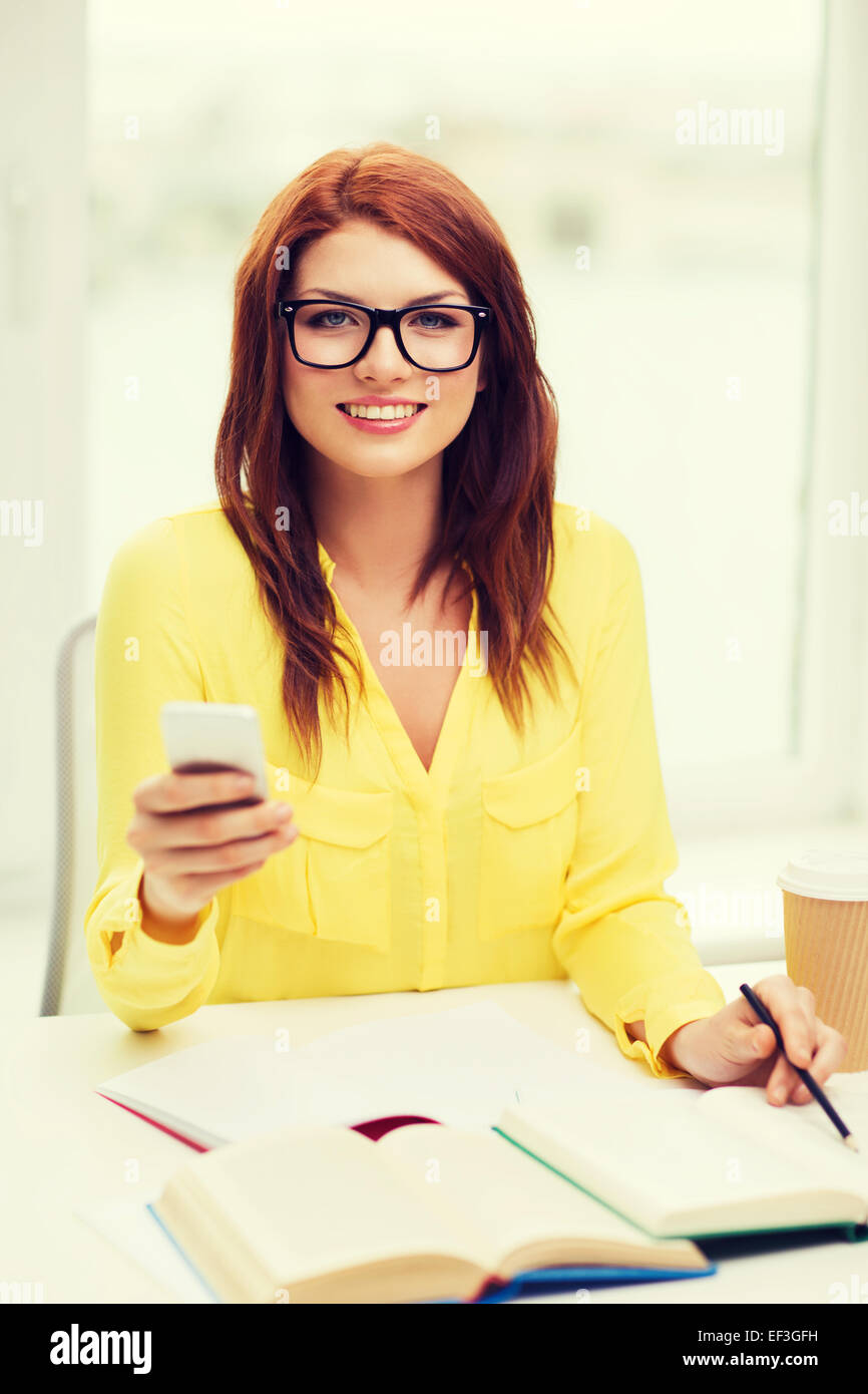 smiling student girl with smartphone at school Stock Photo - Alamy
