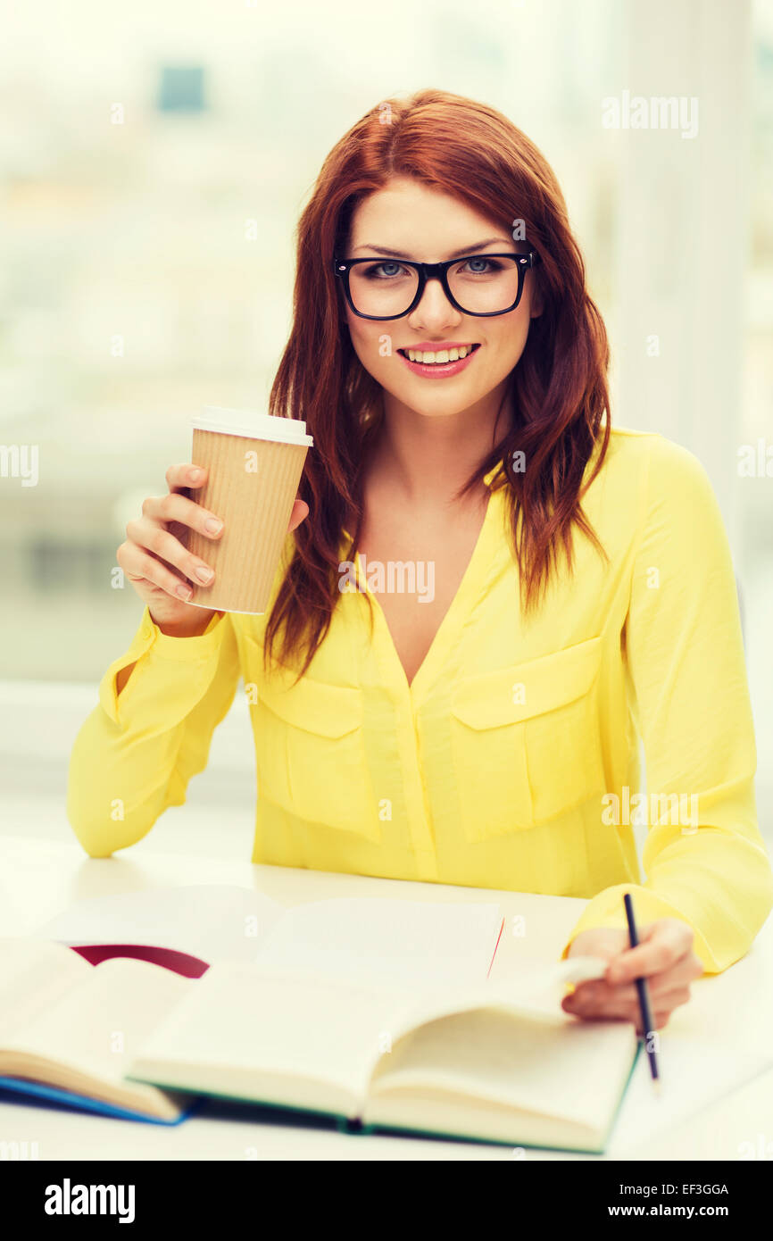 smiling student girl reading books in library Stock Photo - Alamy