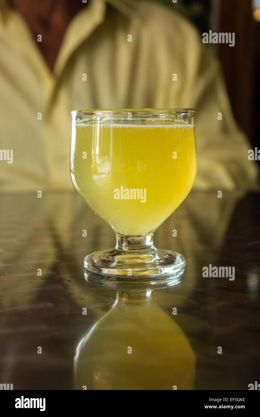 A glass of Poncha stands on a table on the island of Madeira, Portugal ...
