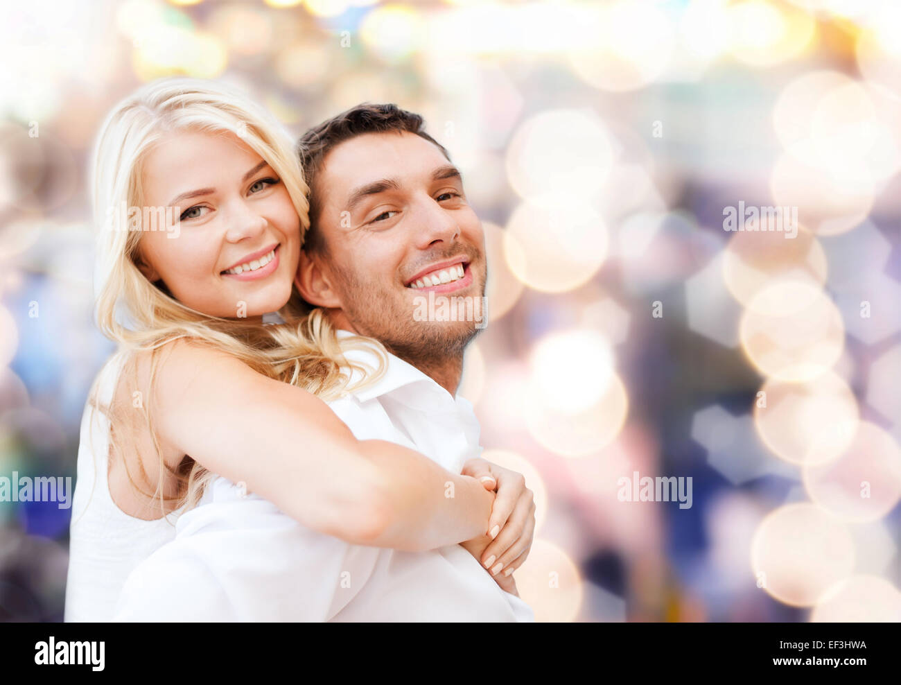 happy couple having fun over lights background Stock Photo - Alamy