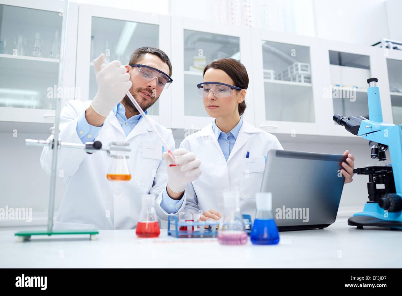 young scientists making test or research in lab Stock Photo - Alamy