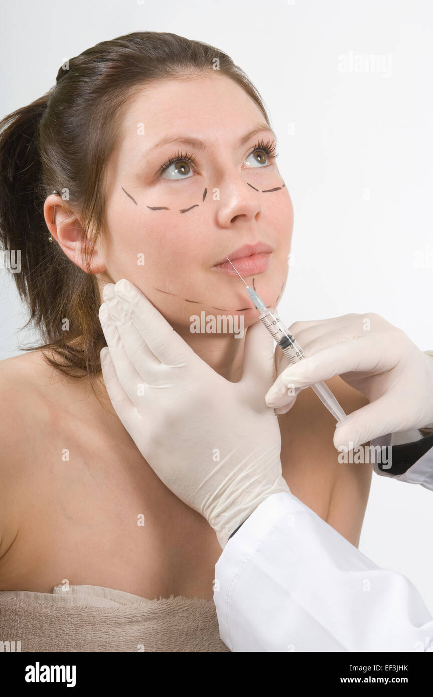 Doctor giving patient a needle on her face Stock Photo - Alamy