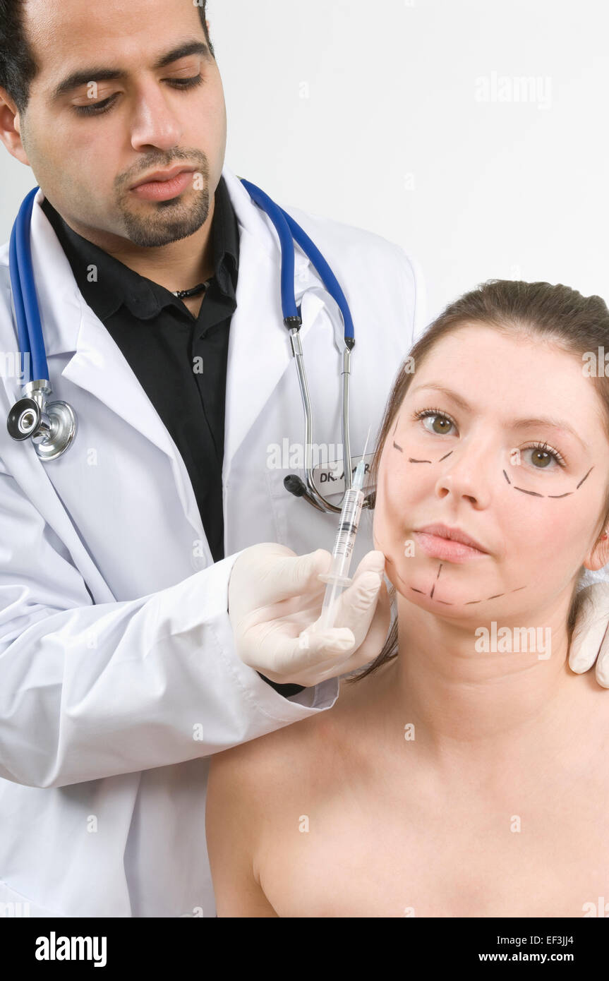 Doctor giving patient a needle on her face Stock Photo - Alamy
