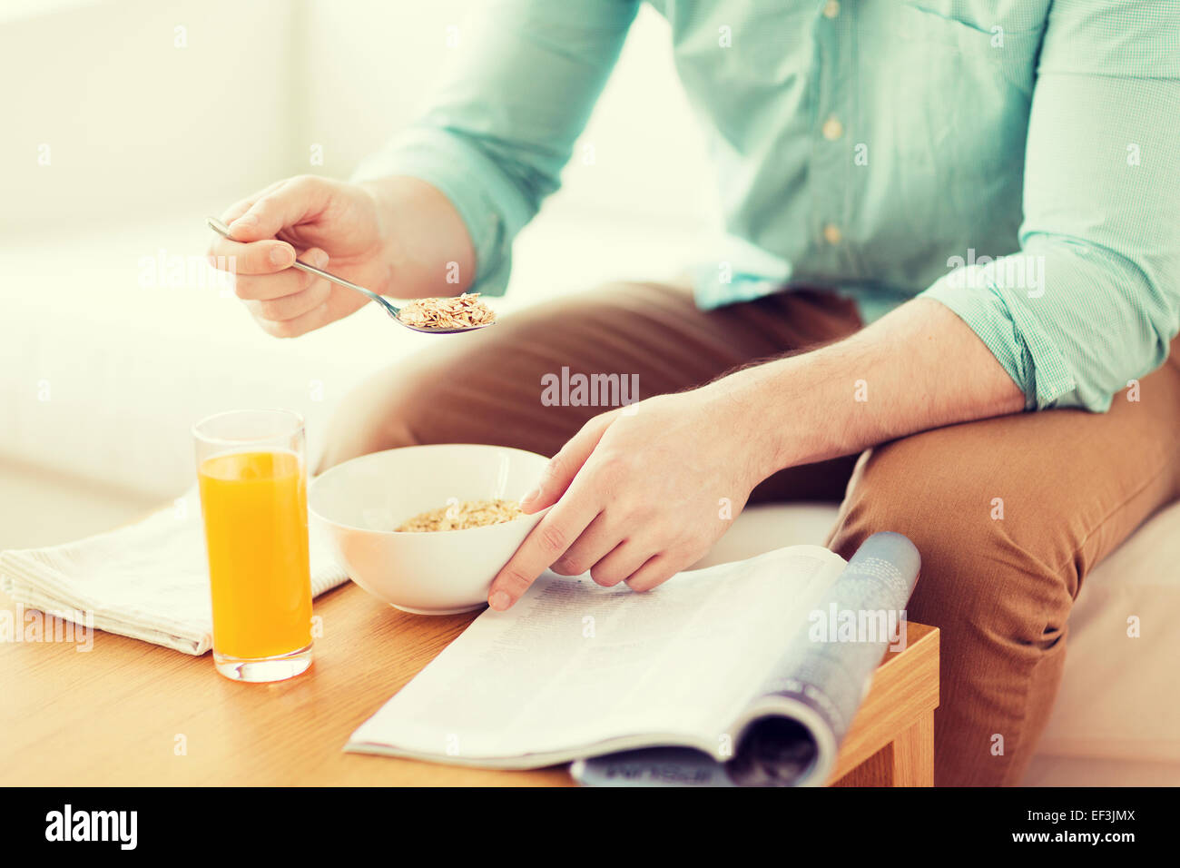 close up of man with magazine eating breakfast Stock Photo - Alamy
