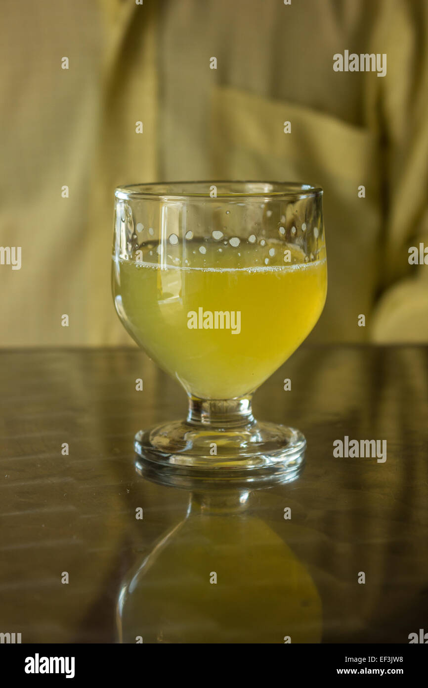 A glass of Poncha stands on a table on the island of Madeira, Portugal ...