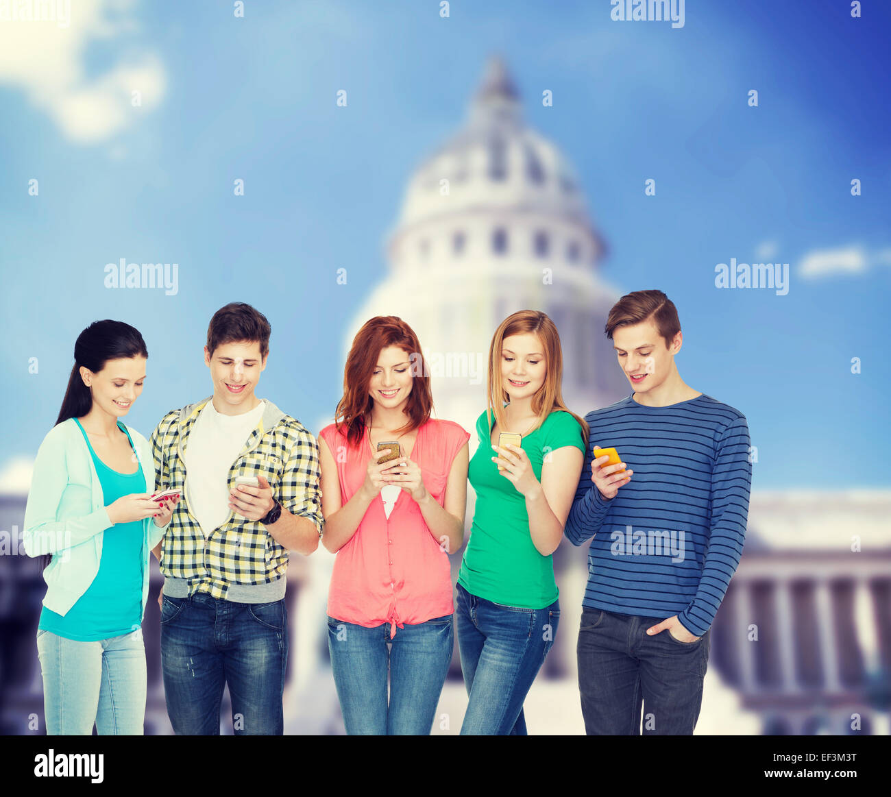 smiling students with smartphones Stock Photo - Alamy