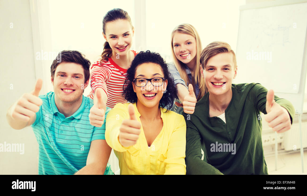 smiling students at school showing thumbs up Stock Photo - Alamy
