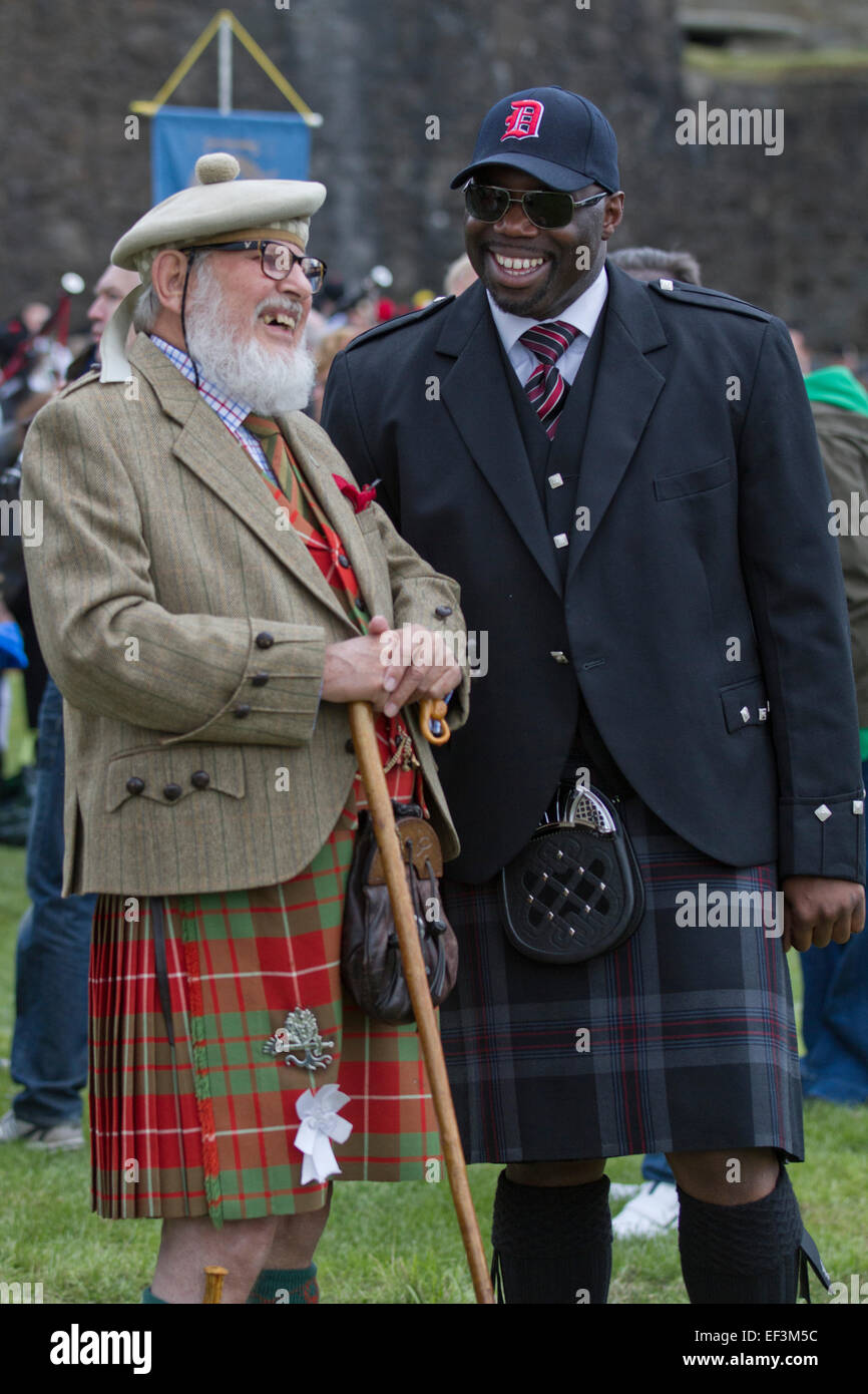 Two men in traditional Scottish kilts laughing before the start of ...