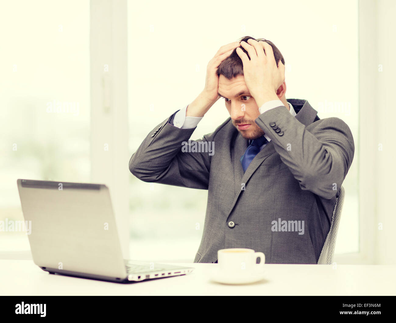 busy businessman with laptop and coffee Stock Photo - Alamy