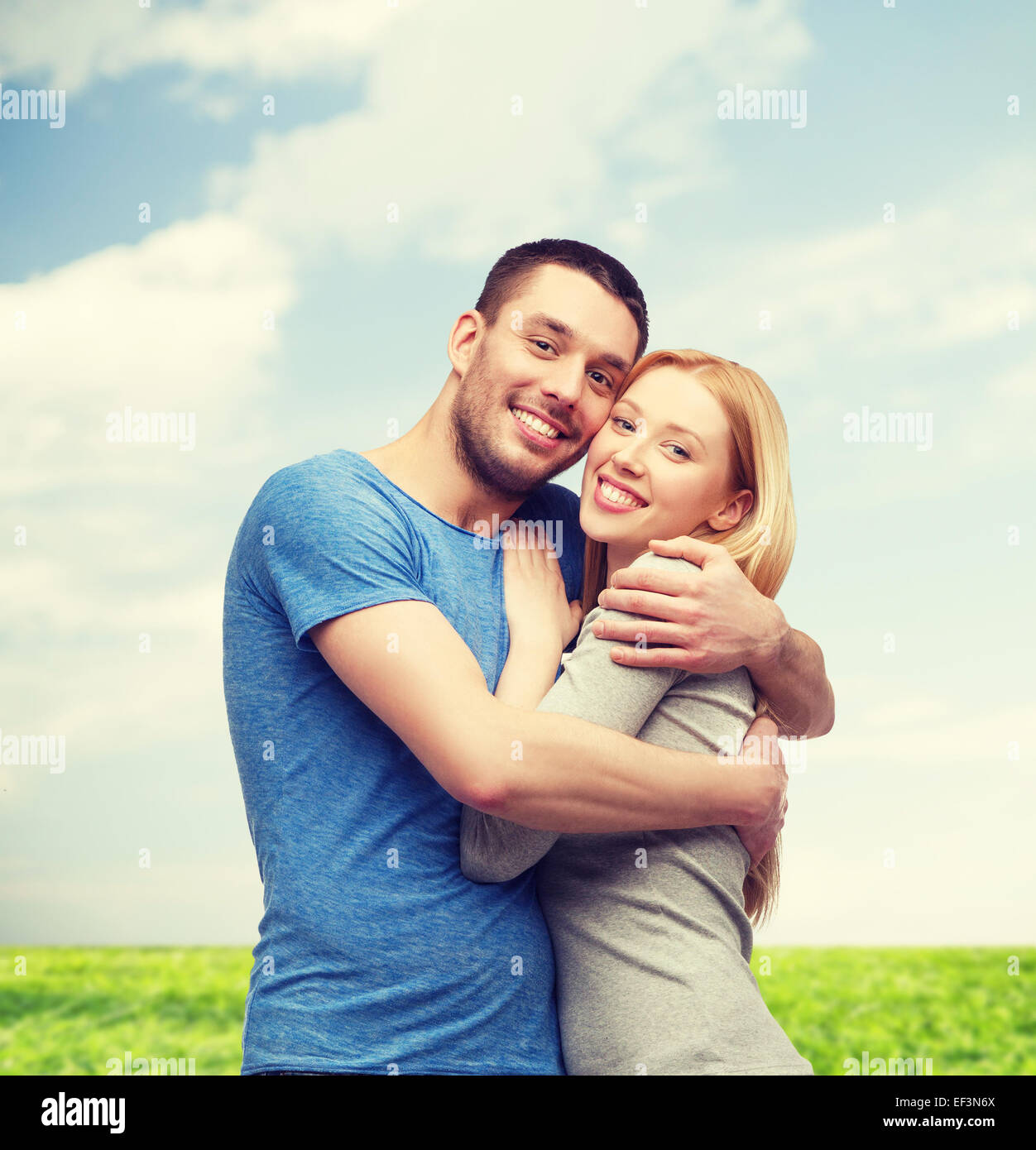 smiling couple hugging Stock Photo - Alamy