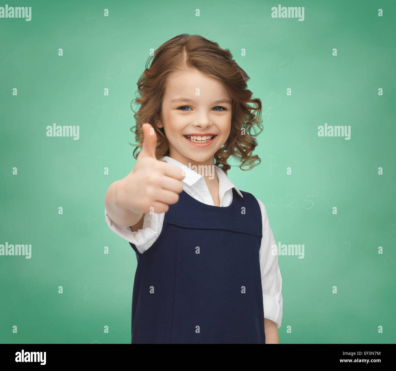 happy little school girl showing thumbs up Stock Photo - Alamy