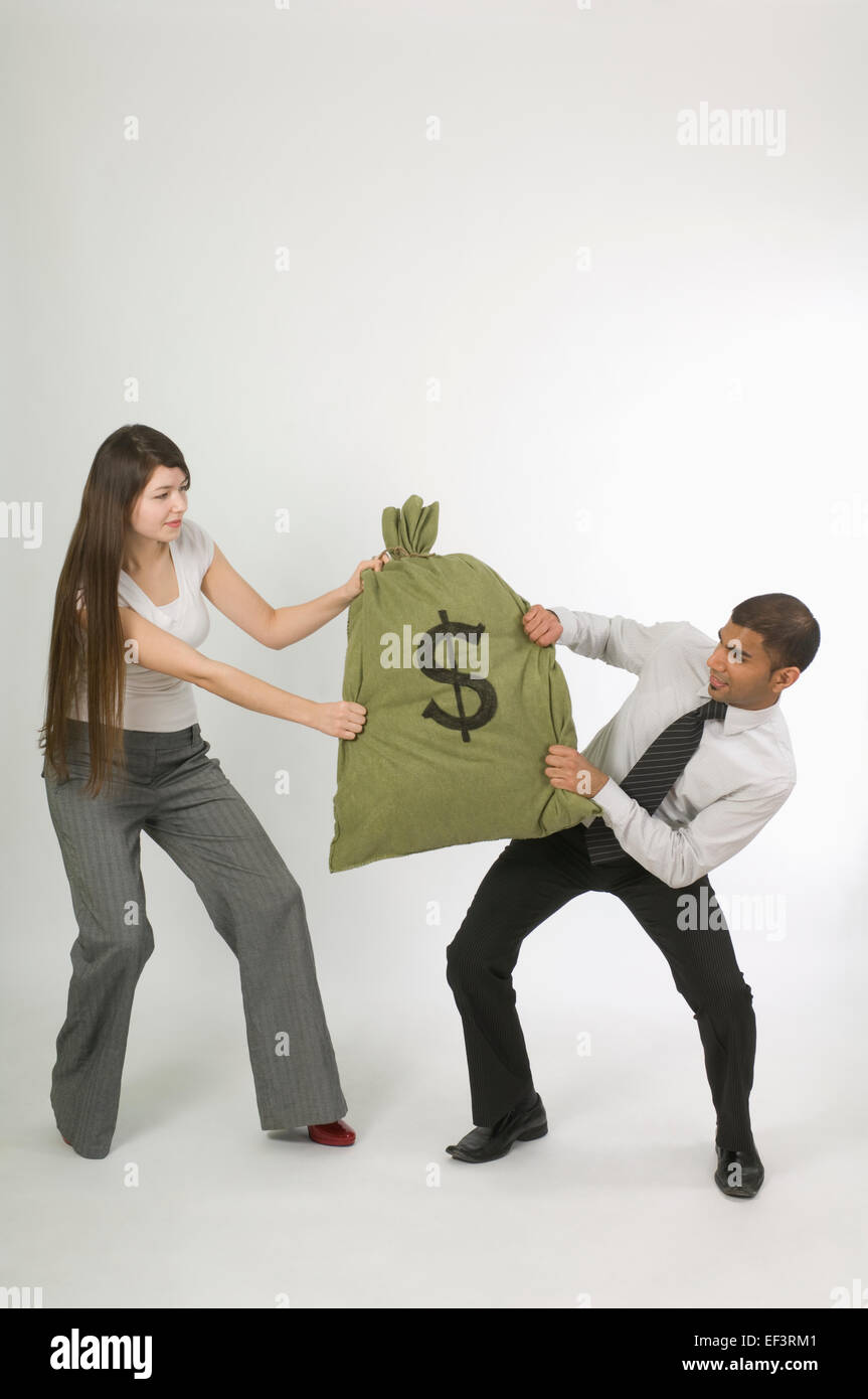 Couple fighting over a bag of money Stock Photo - Alamy