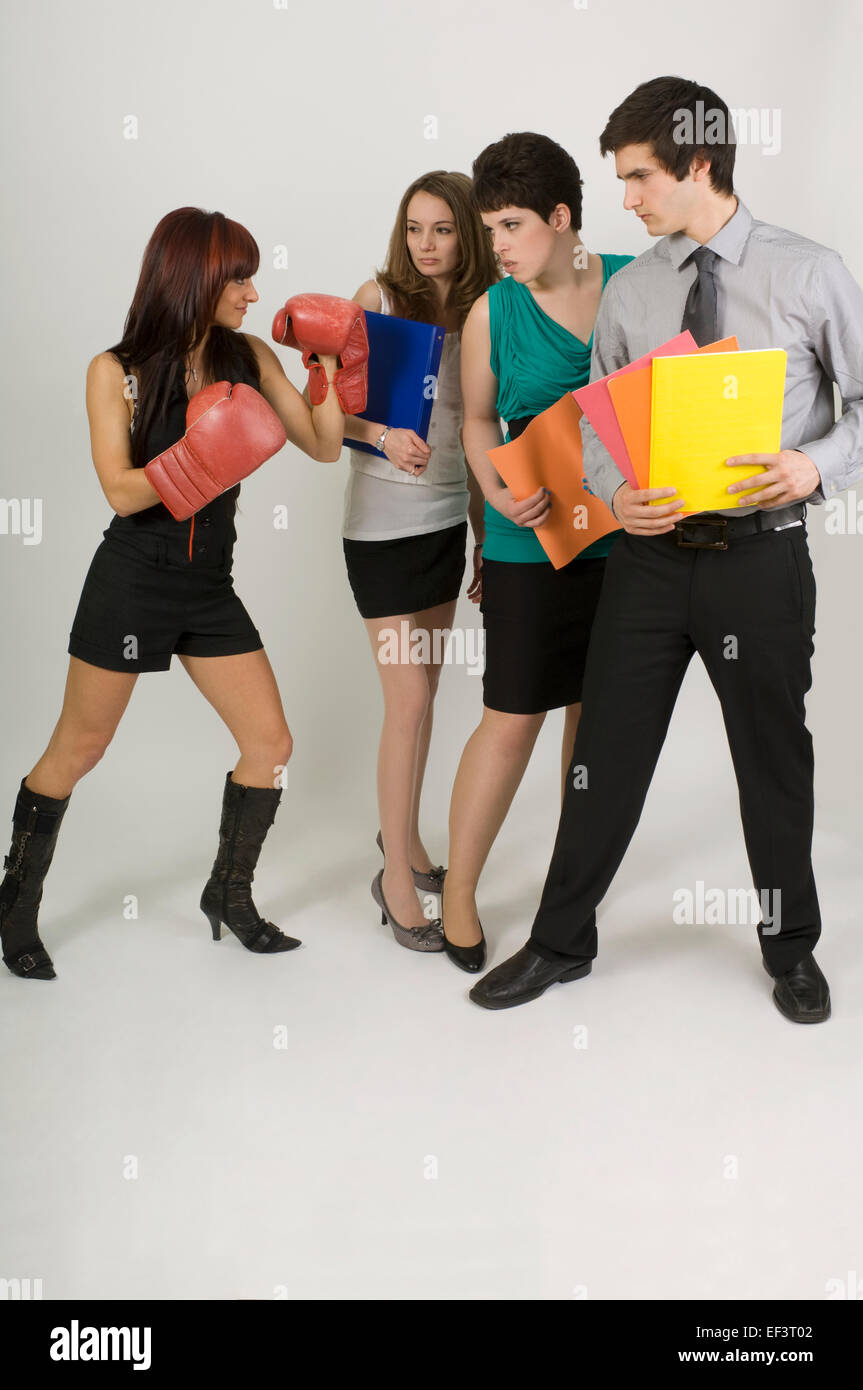 Three people looking at woman wearing boxing gloves Stock Photo - Alamy