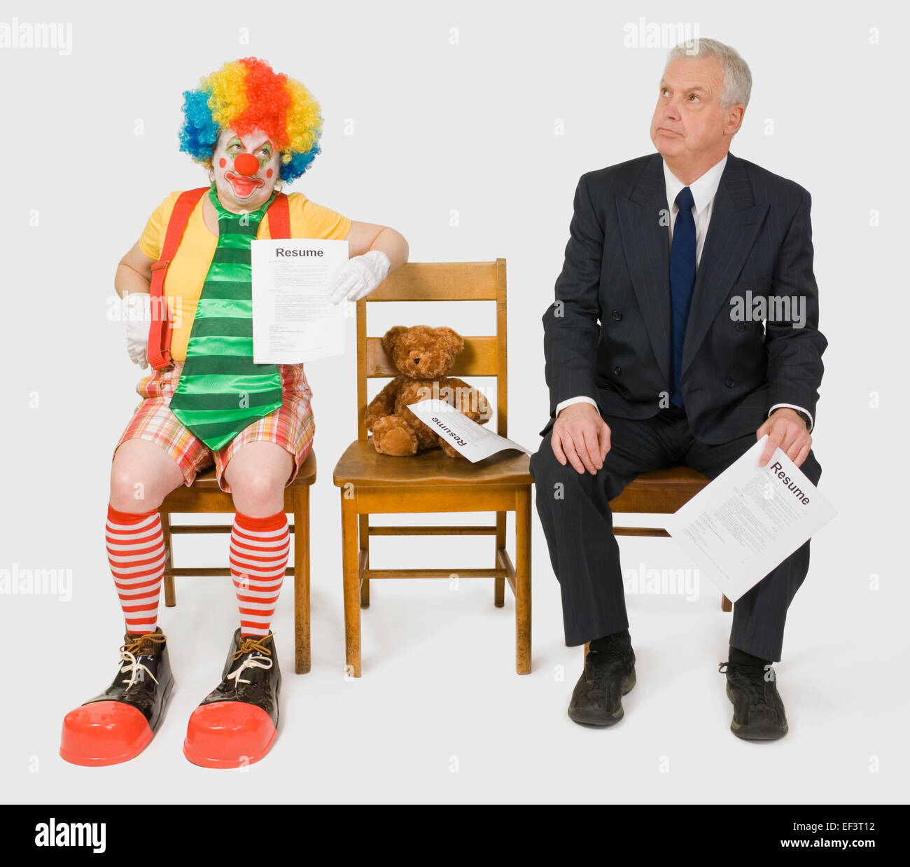 Businessman and clown waiting for an interview Stock Photo - Alamy