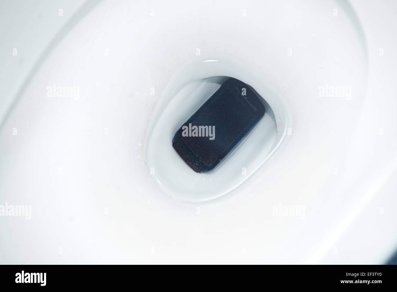 Smartphone dropped to the toilet bowl. Horizontal photo Stock Photo - Alamy
