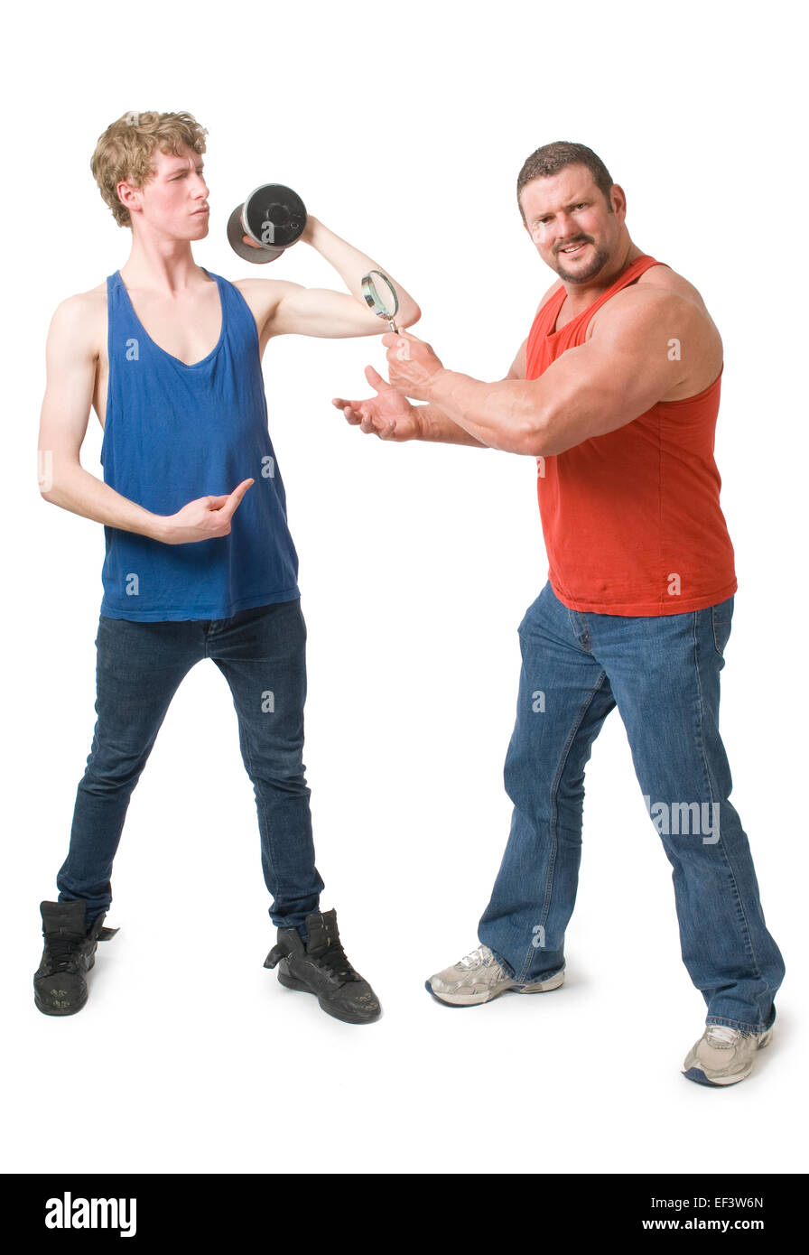 Man using magnifying glass to look for another man's muscles Stock ...