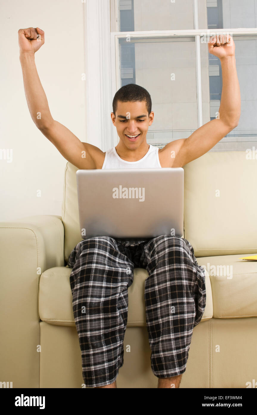 Happy man looking at laptop Stock Photo - Alamy