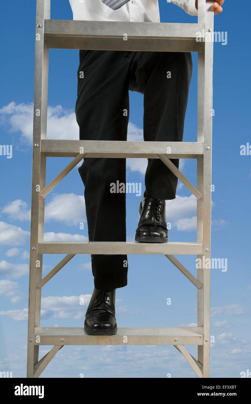 Businessman climbing ladder in the sky Stock Photo - Alamy