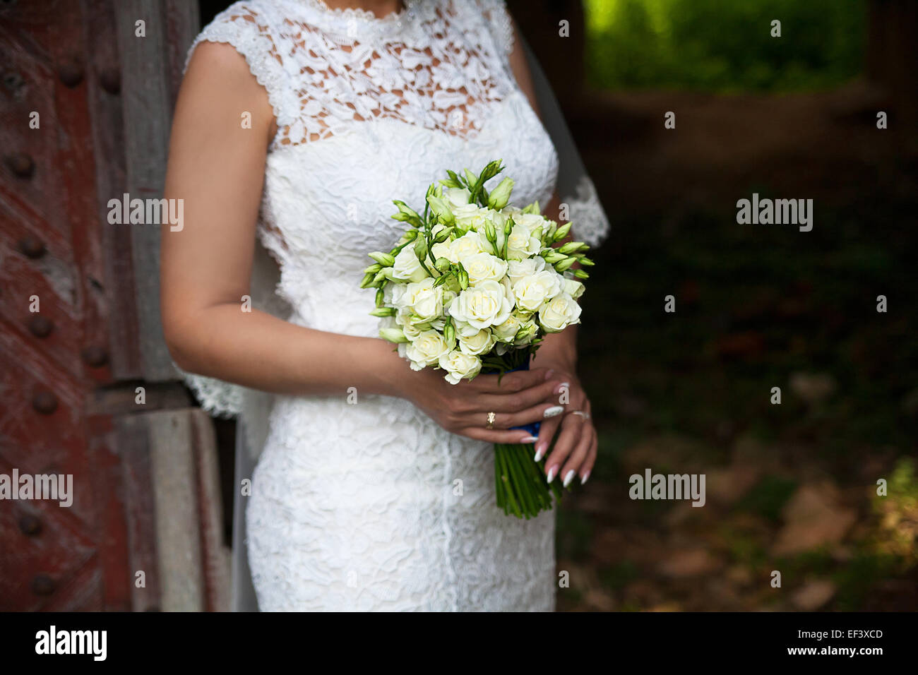 Bride holding wedding flower bouquet of roses Stock Photo - Alamy