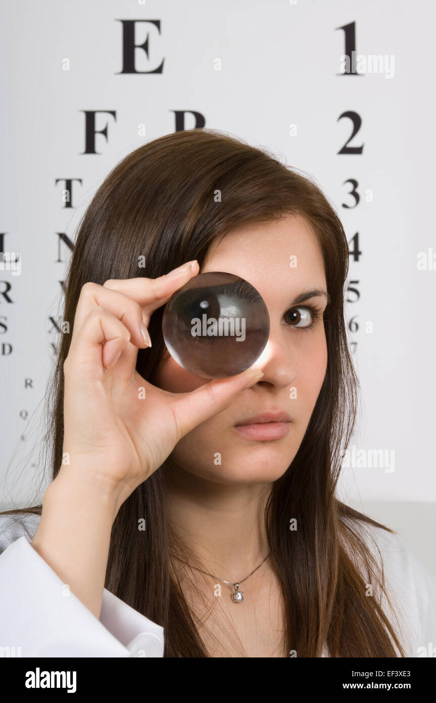 Optometrist looking through lens Stock Photo - Alamy