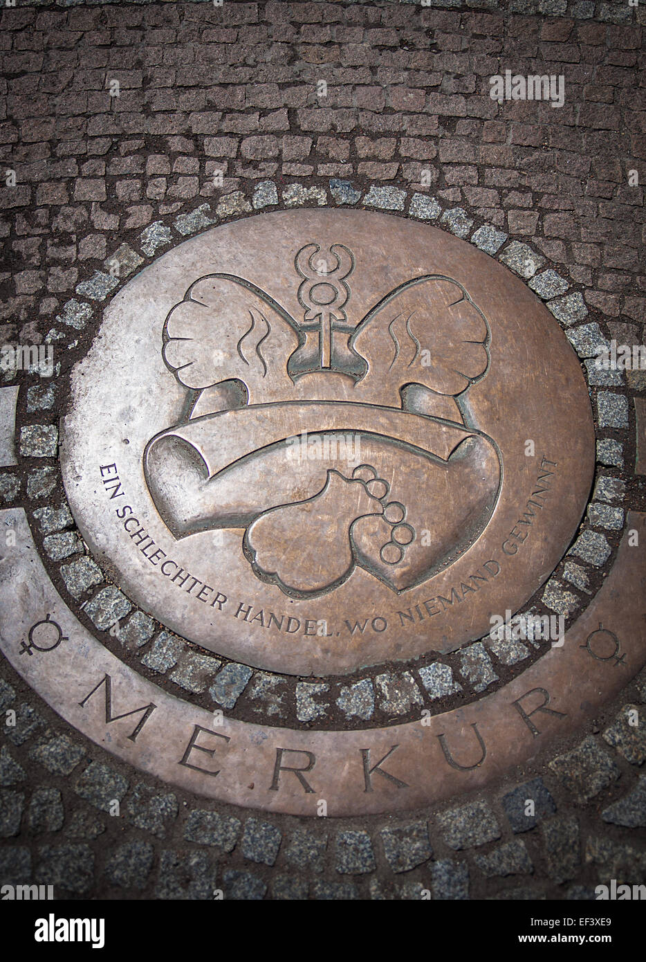 Round Iron hatch for sewer on cobblestone pavement Stock Photo - Alamy
