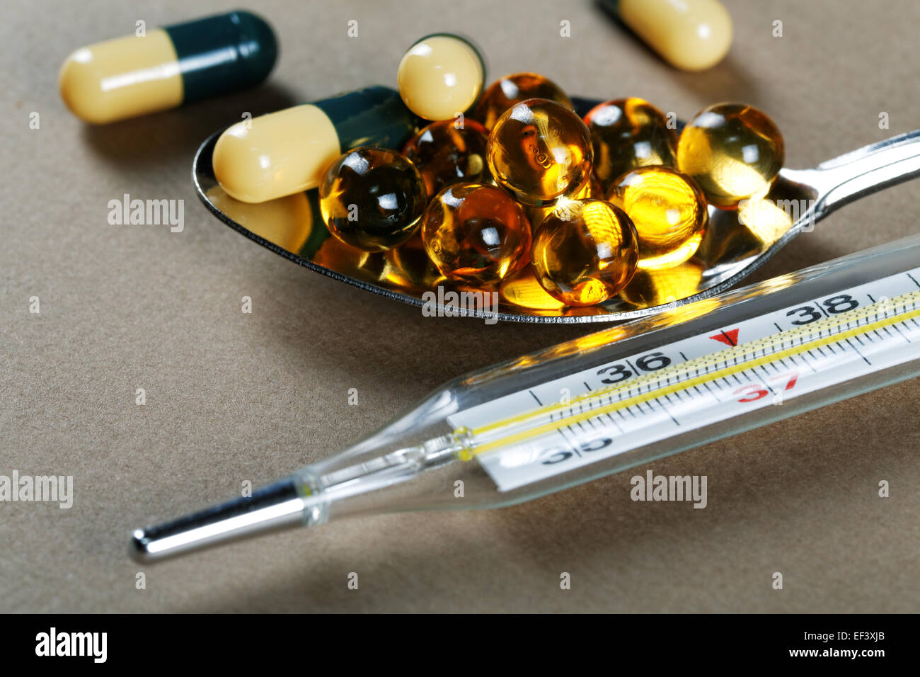 The thermometer and capsules with medicines close up Stock Photo - Alamy