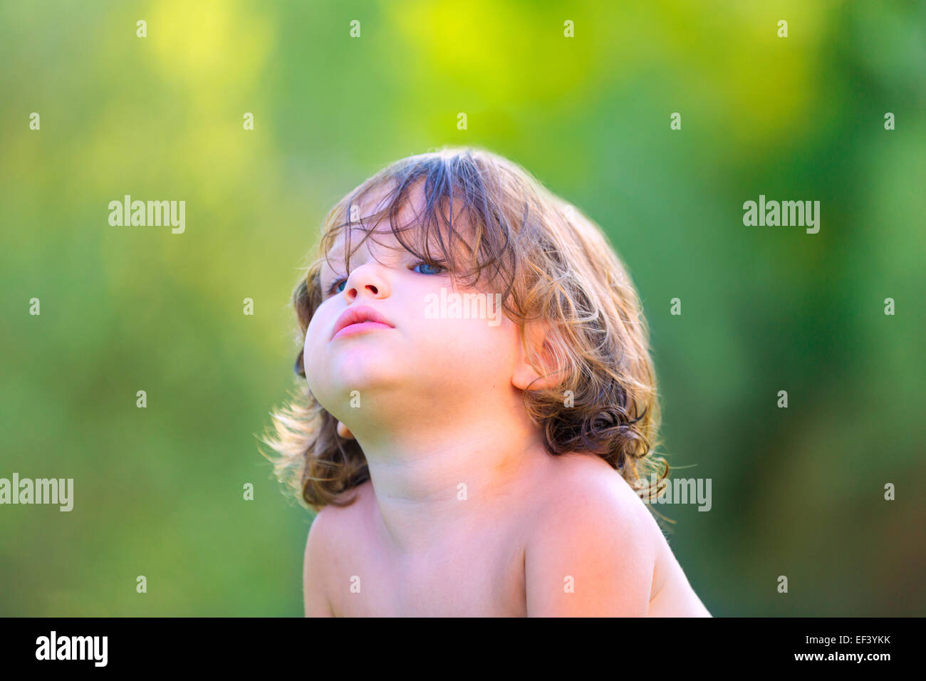 Baby kid girl in summer on green field background Stock Photo - Alamy