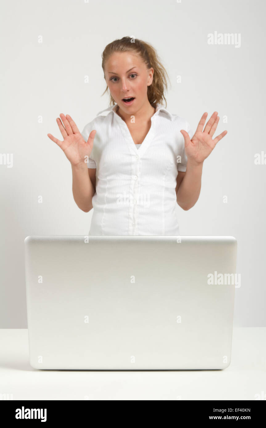 Woman gestures surprise laptop hi-res stock photography and images - Alamy