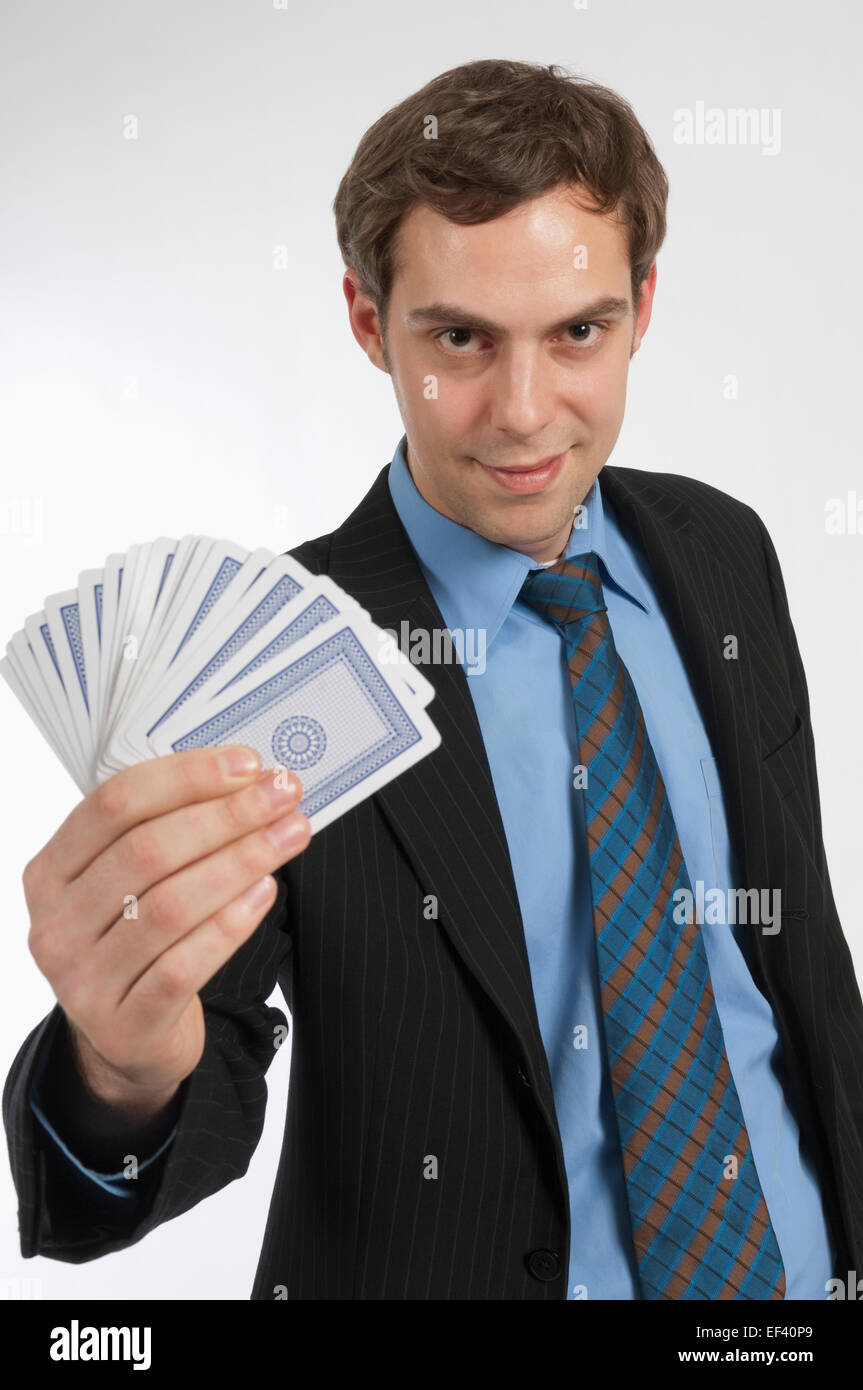 Businessman holding a deck of cards Stock Photo - Alamy