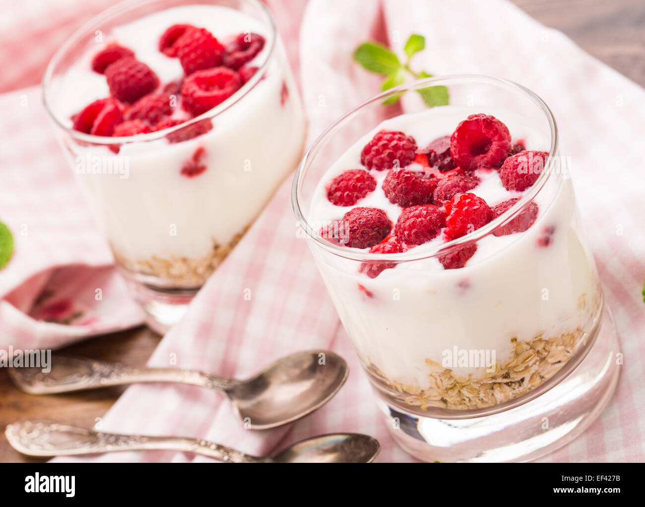 Yogurt with muesli and raspberries Stock Photo - Alamy