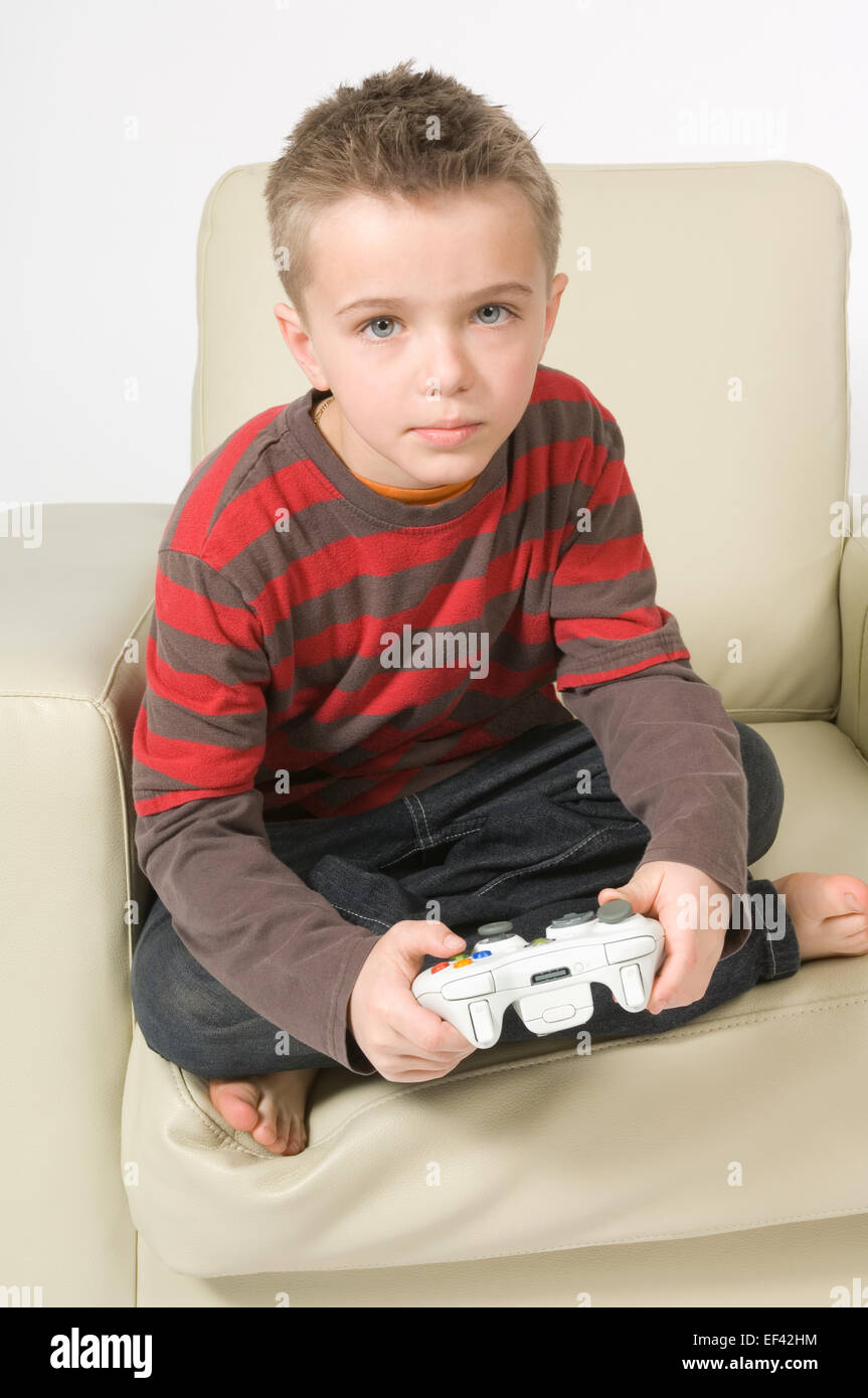 Young boy playing video game Stock Photo - Alamy