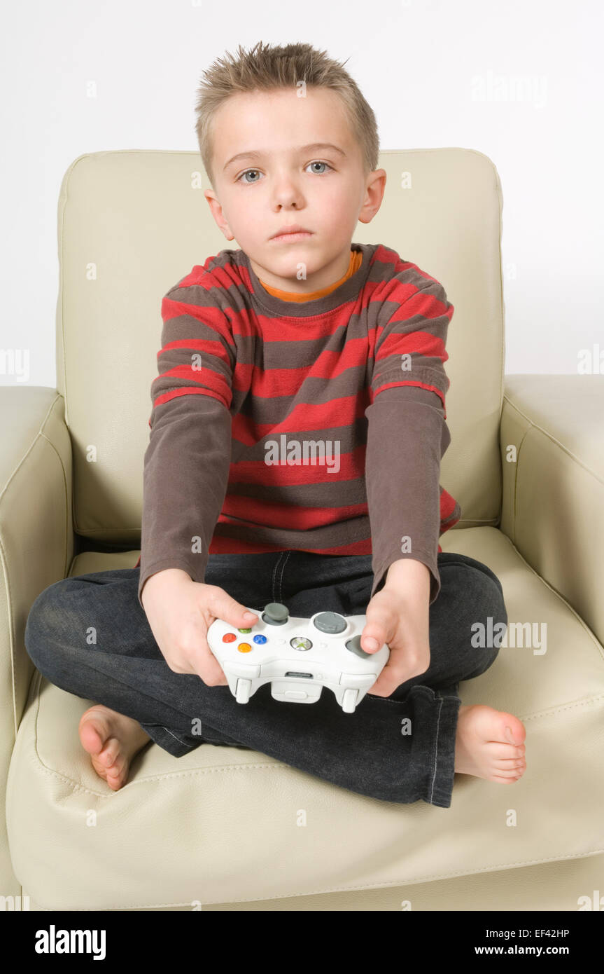 Young boy playing video game Stock Photo - Alamy