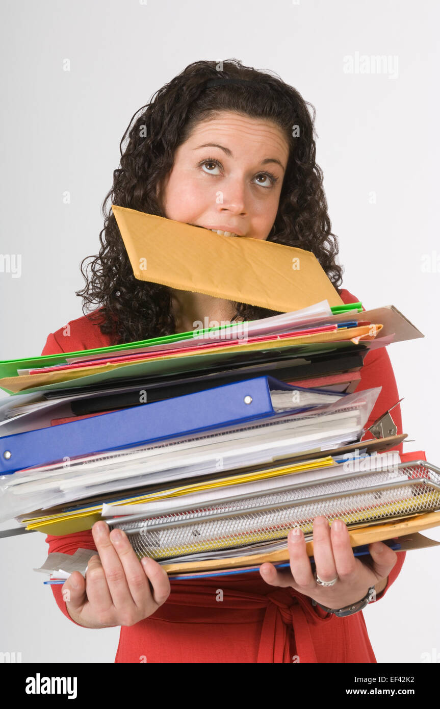 Woman carrying large stack of paperwork Stock Photo - Alamy