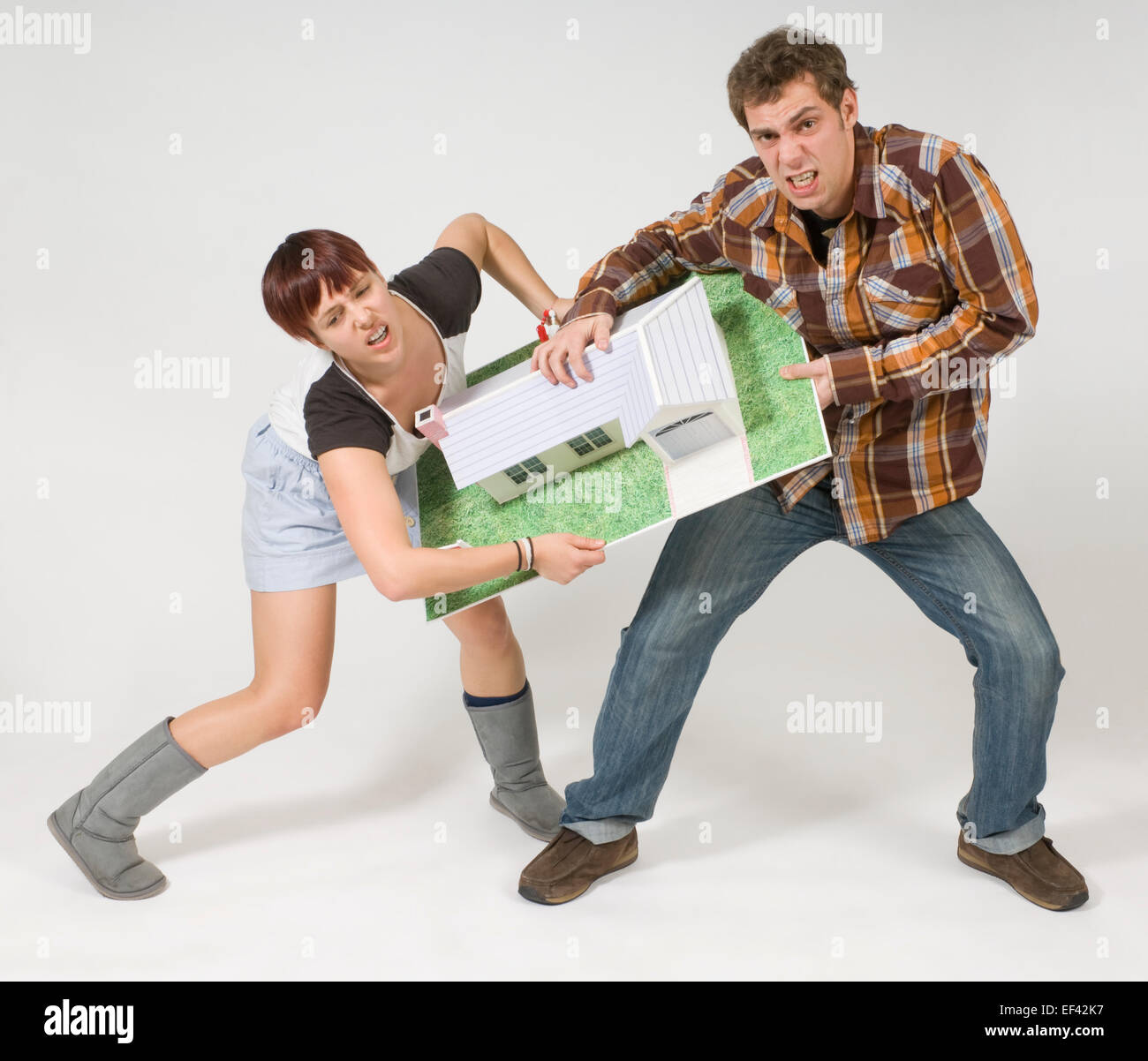 Couple fighting over model home Stock Photo - Alamy