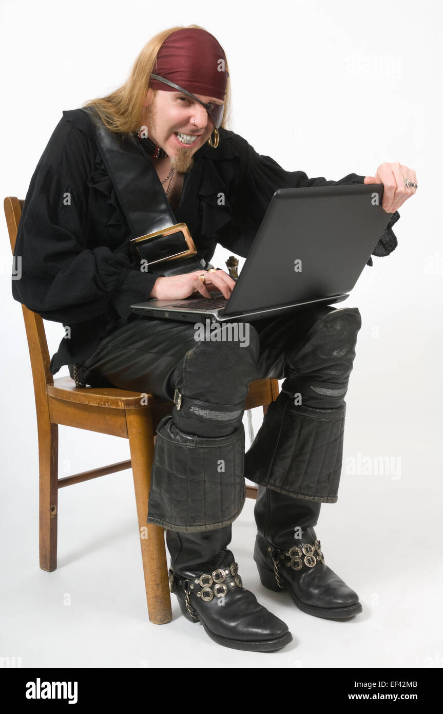 Pirate typing on laptop Stock Photo - Alamy
