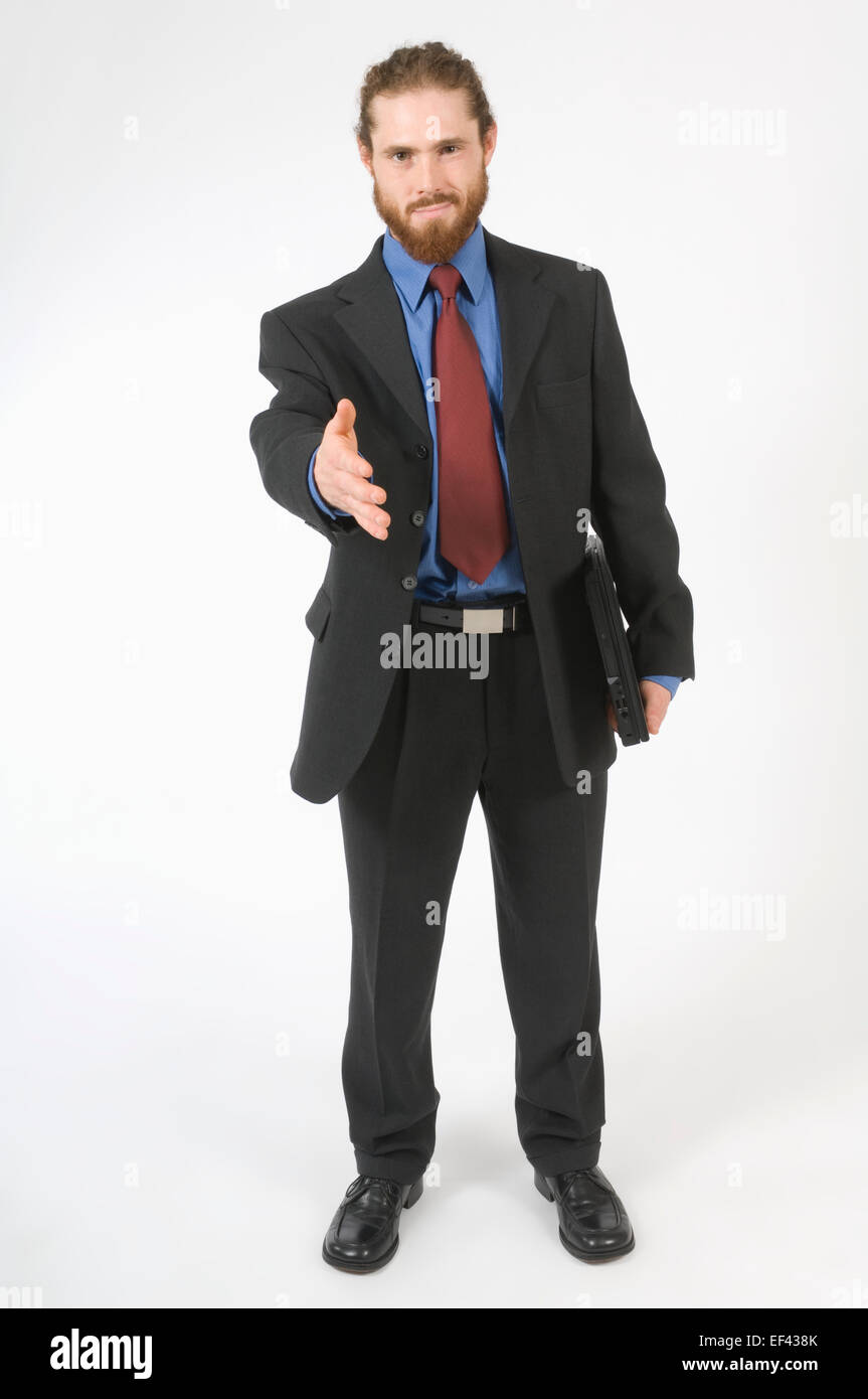 Businessman extending his arm for a handshake Stock Photo - Alamy