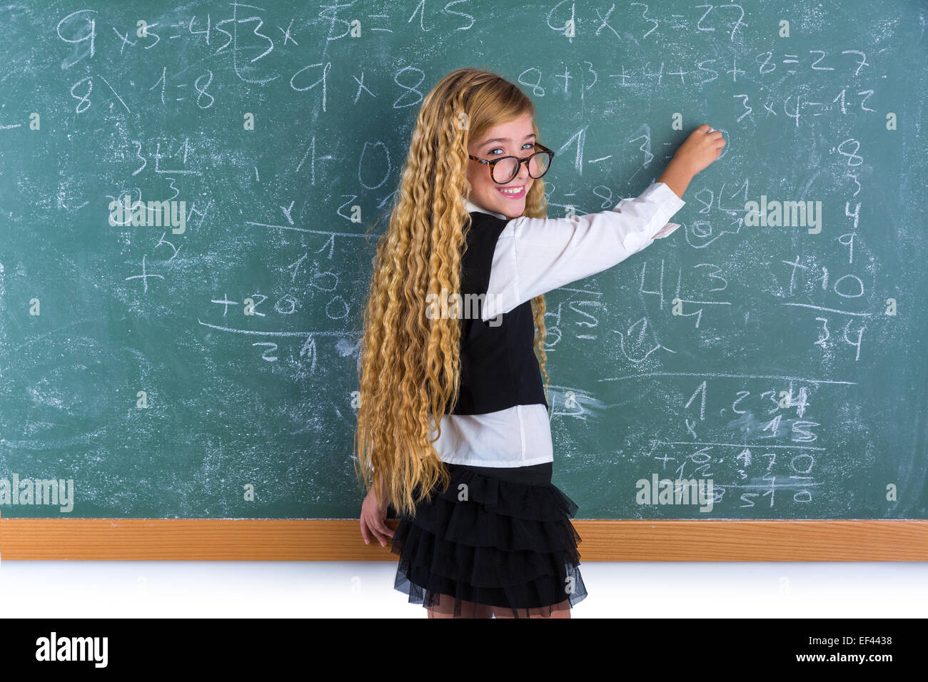Clever nerd pupil blond girl writing in green board student schoolgirl ...