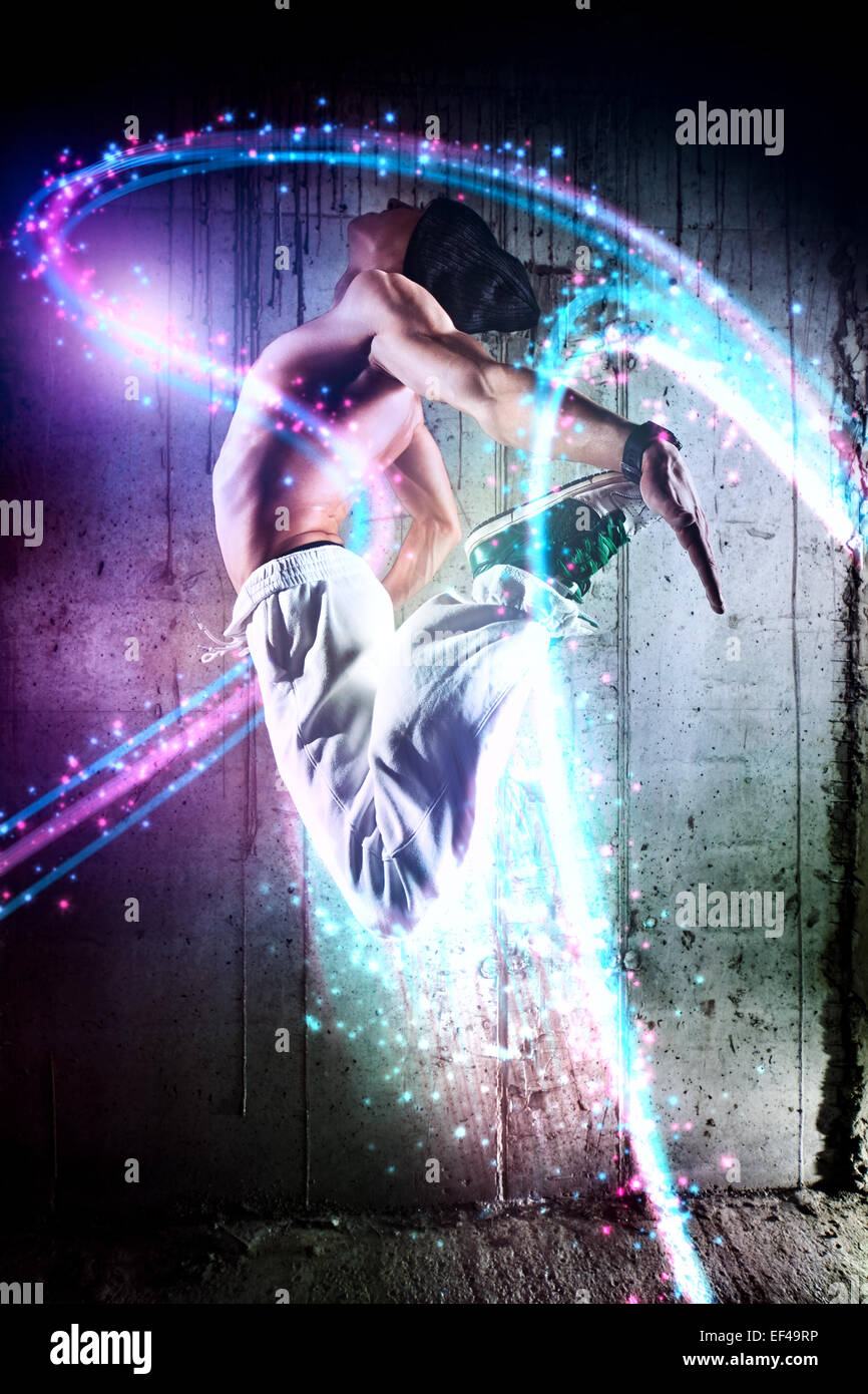 Young man dancer jumping. With light effects Stock Photo - Alamy