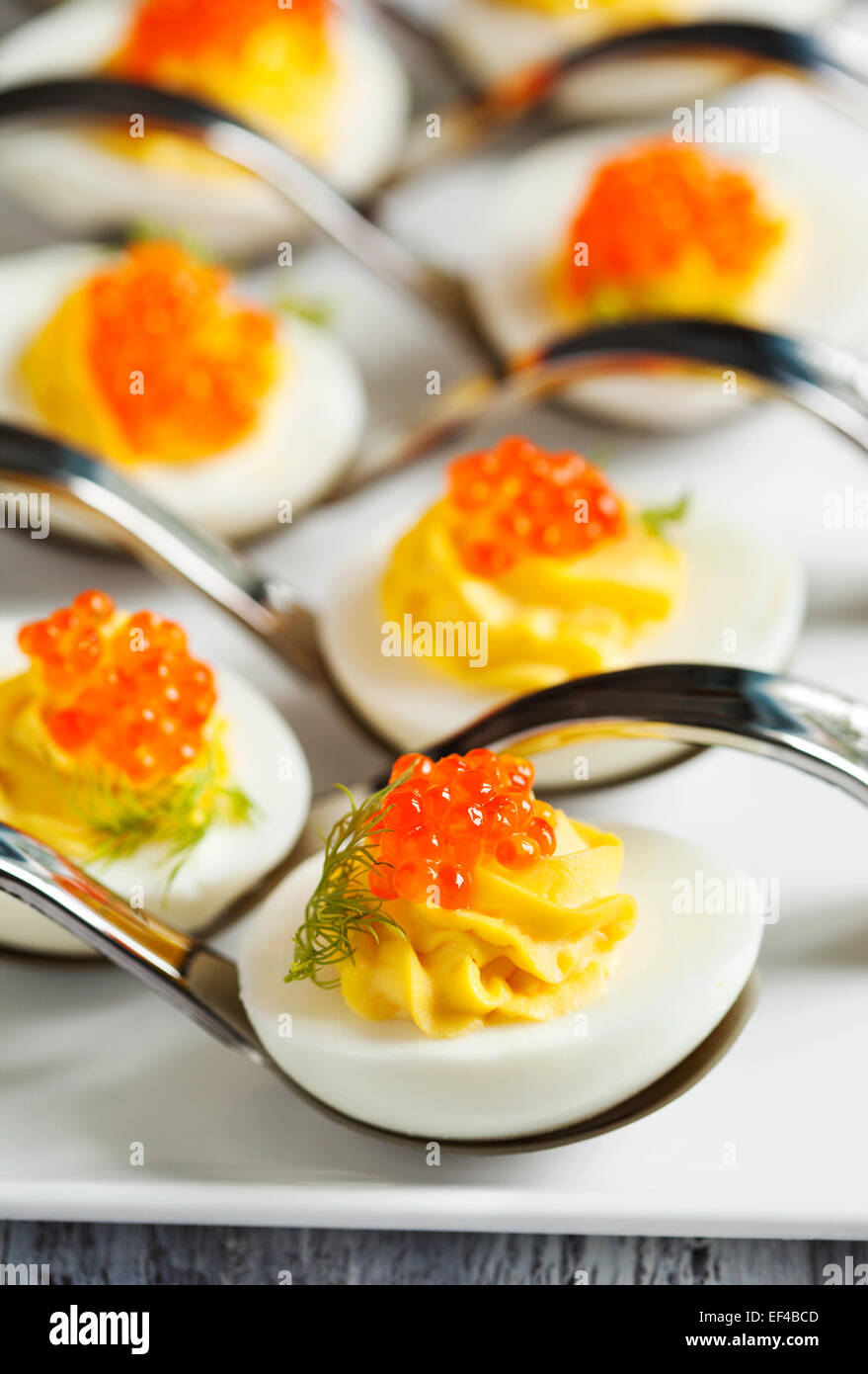 Deviled eggs with red caviar in a spoon Stock Photo - Alamy