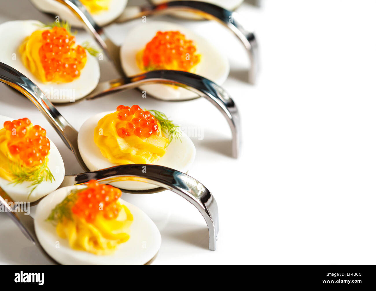 Deviled eggs with red caviar in a spoon Stock Photo - Alamy