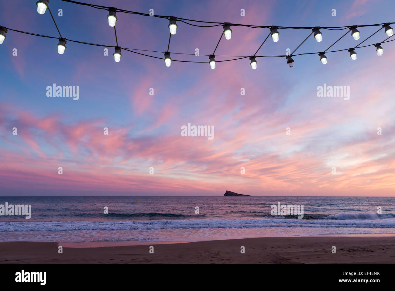row of light bulbs on the beach at sunset Stock Photo - Alamy