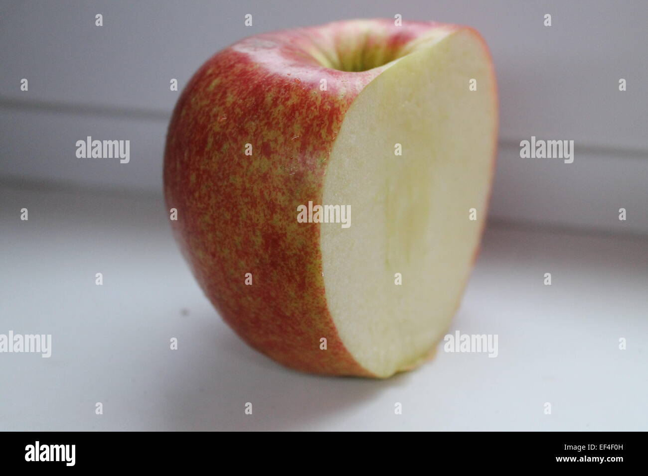 appetizing fresh pulp sweet red apple cut on half Stock Photo - Alamy