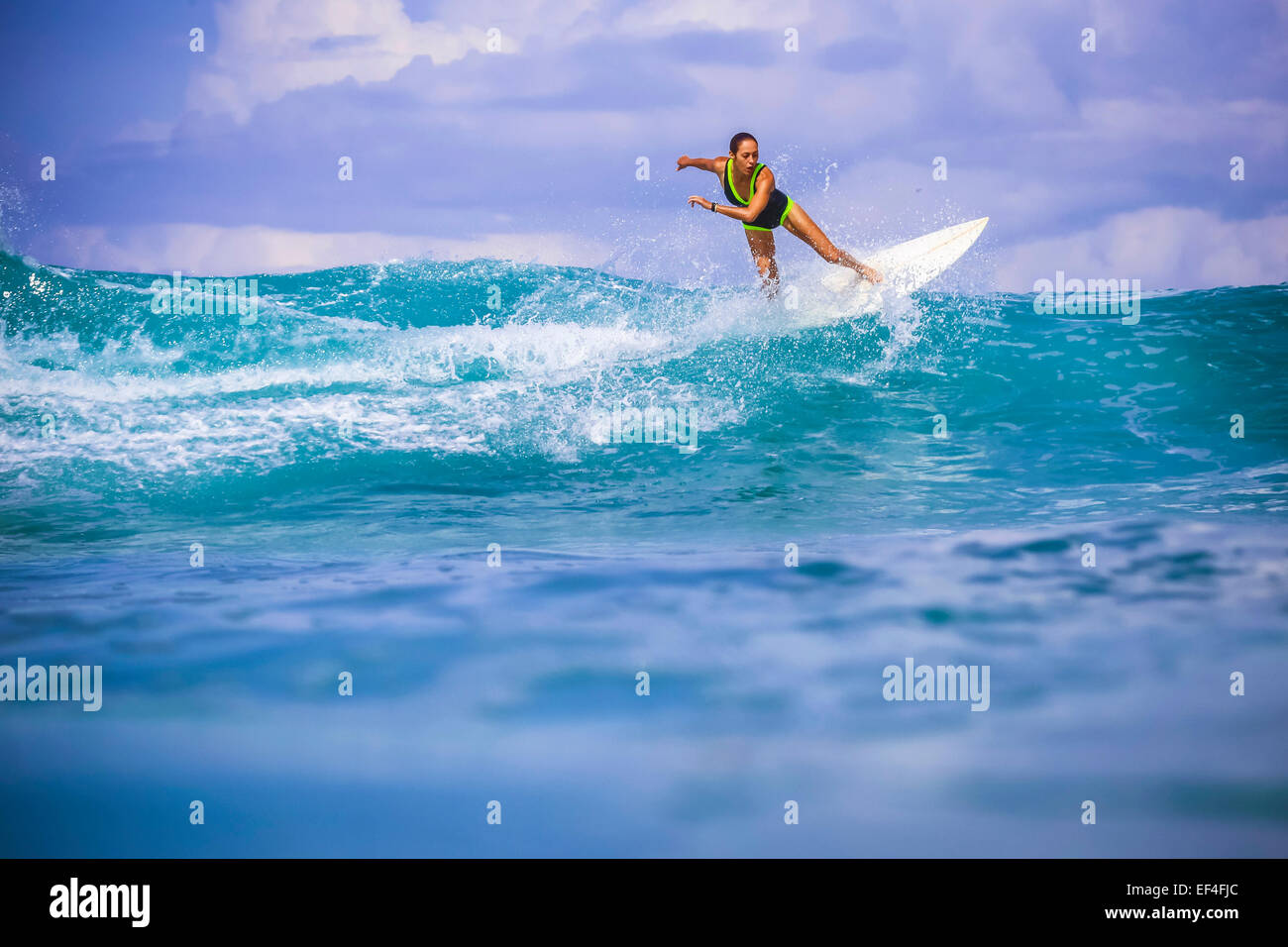 Surfer girl on Amazing Blue Wave, Bali island Stock Photo - Alamy
