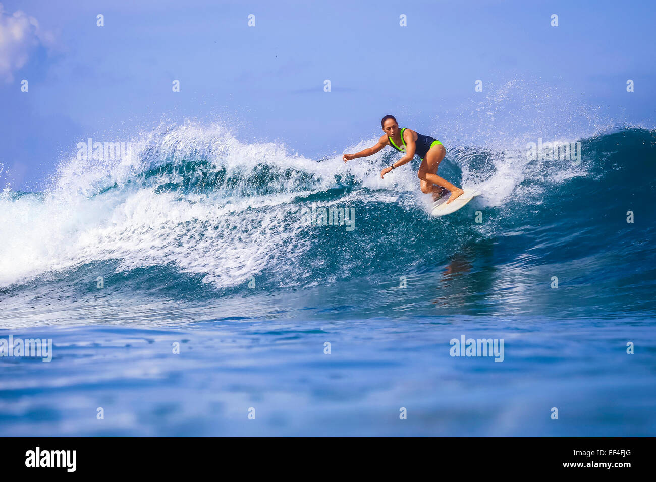 Surfer girl on Amazing Blue Wave, Bali island Stock Photo - Alamy