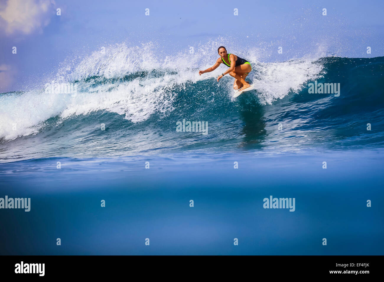 Surfer girl on Amazing Blue Wave, Bali island Stock Photo - Alamy