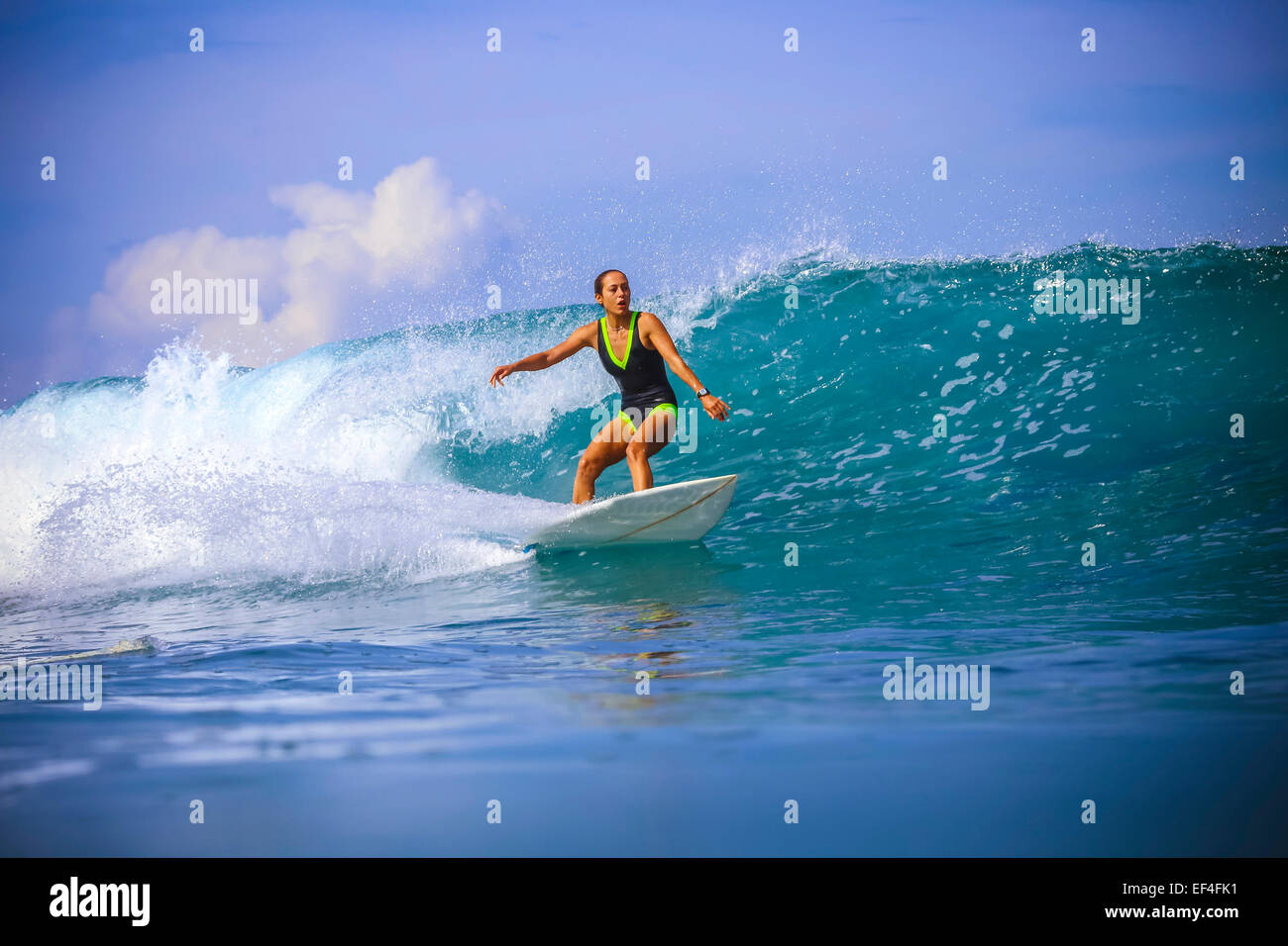 Surfer girl on Amazing Blue Wave, Bali island Stock Photo - Alamy