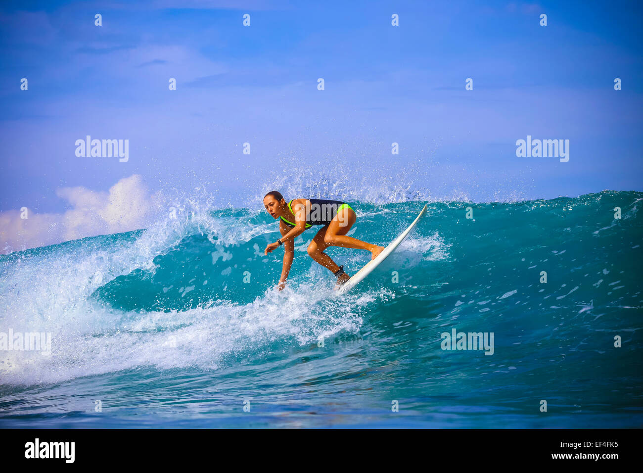 Surfer girl on Amazing Blue Wave, Bali island Stock Photo - Alamy
