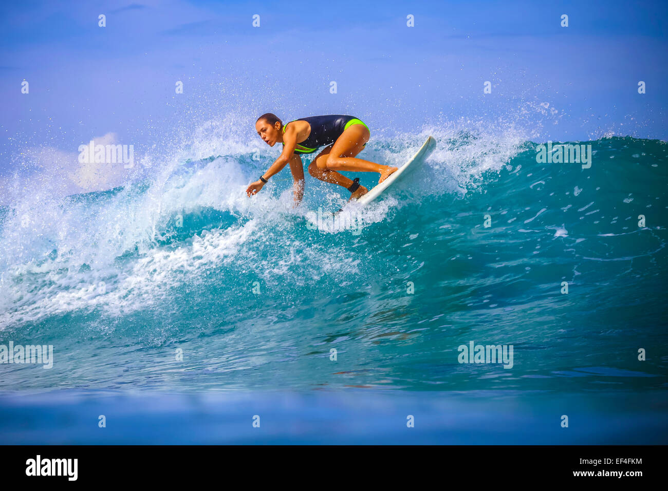 Surfer girl on Amazing Blue Wave, Bali island Stock Photo - Alamy