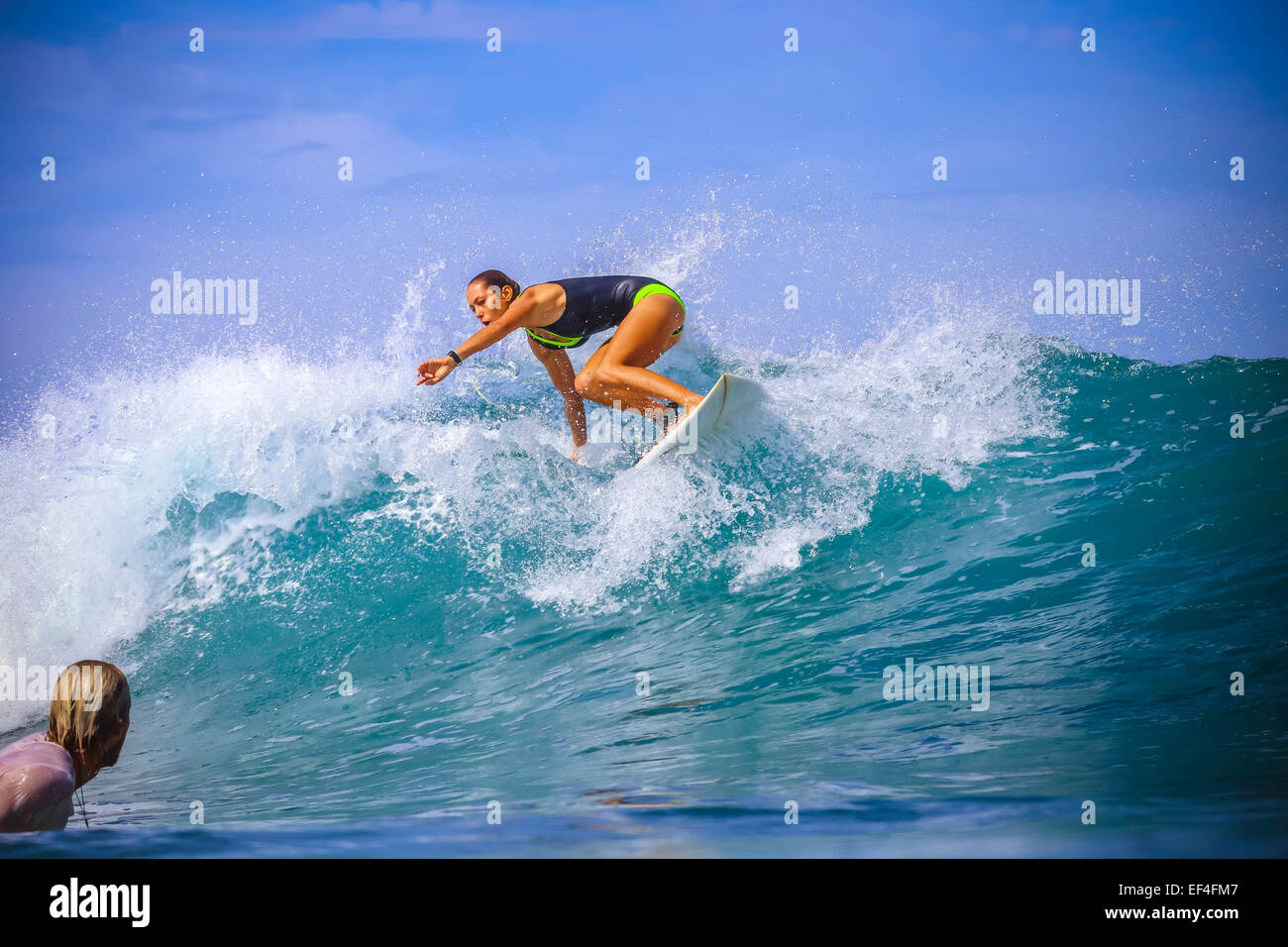 Surfer girl on Amazing Blue Wave, Bali island Stock Photo - Alamy