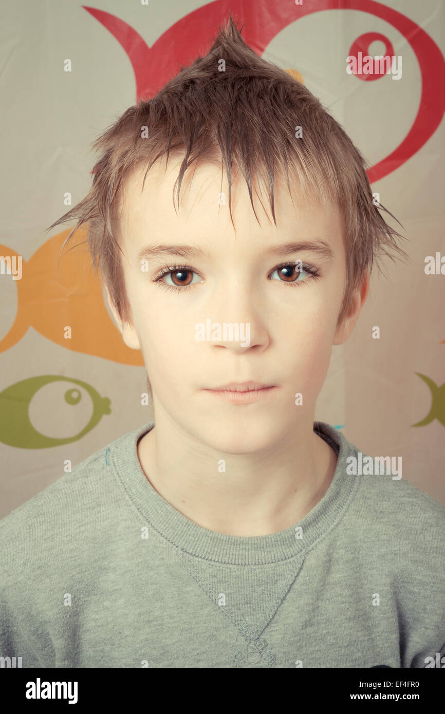 Young boy in bathroom looking at camera Stock Photo - Alamy